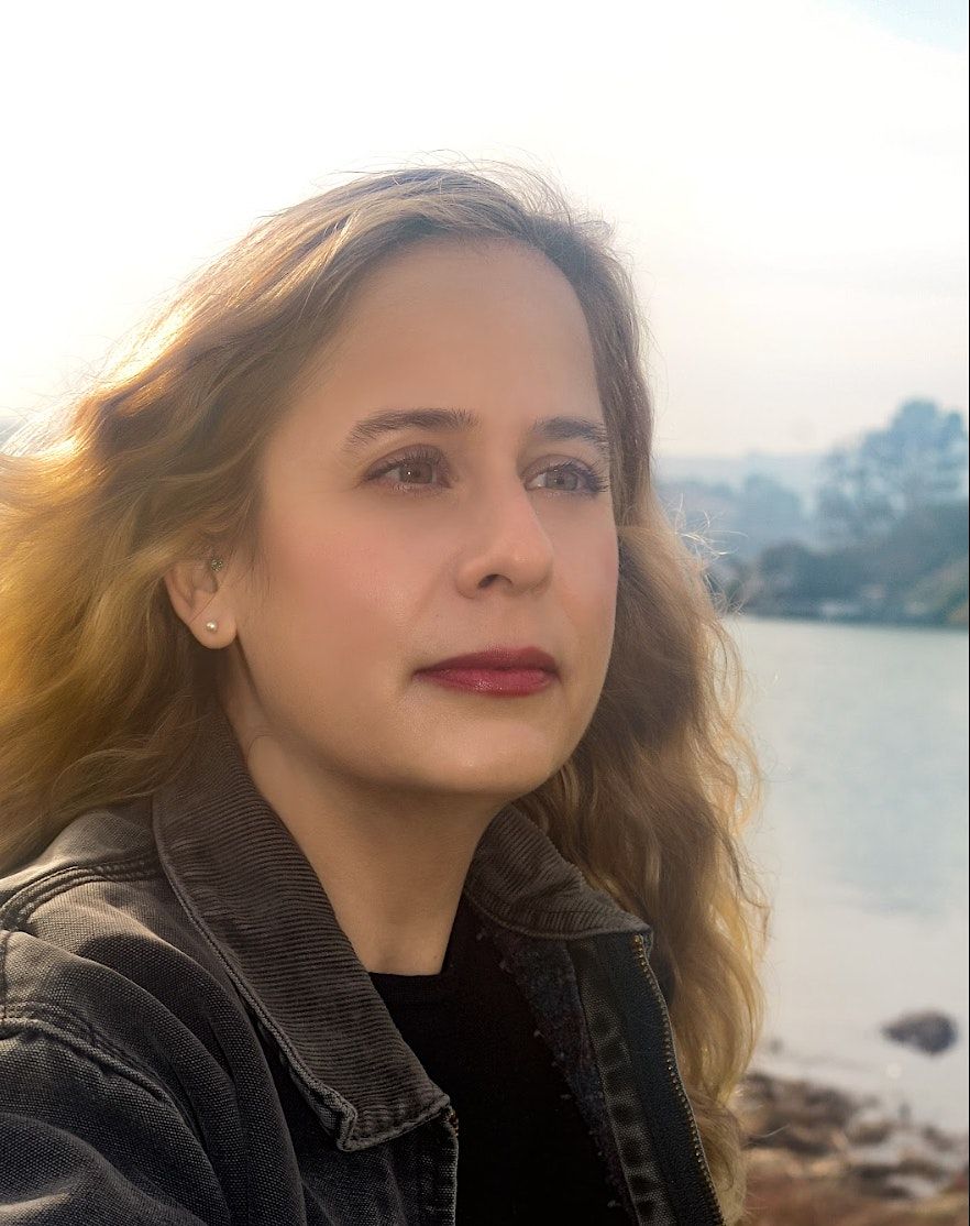 Poet Karen Poppy with their new book, Diving at the Lip of the Water at ...